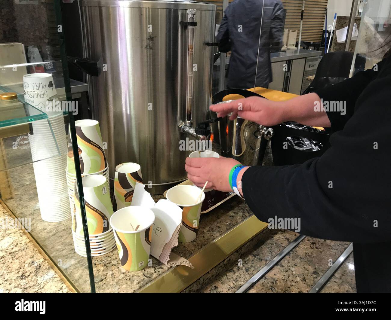 Cologne, Germany - March 23, 2022 - Person is pouring coffee into a cup ...