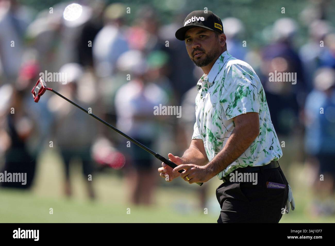 Jason Day, of Australia, reacts after missing a putt on the sixth hole ...