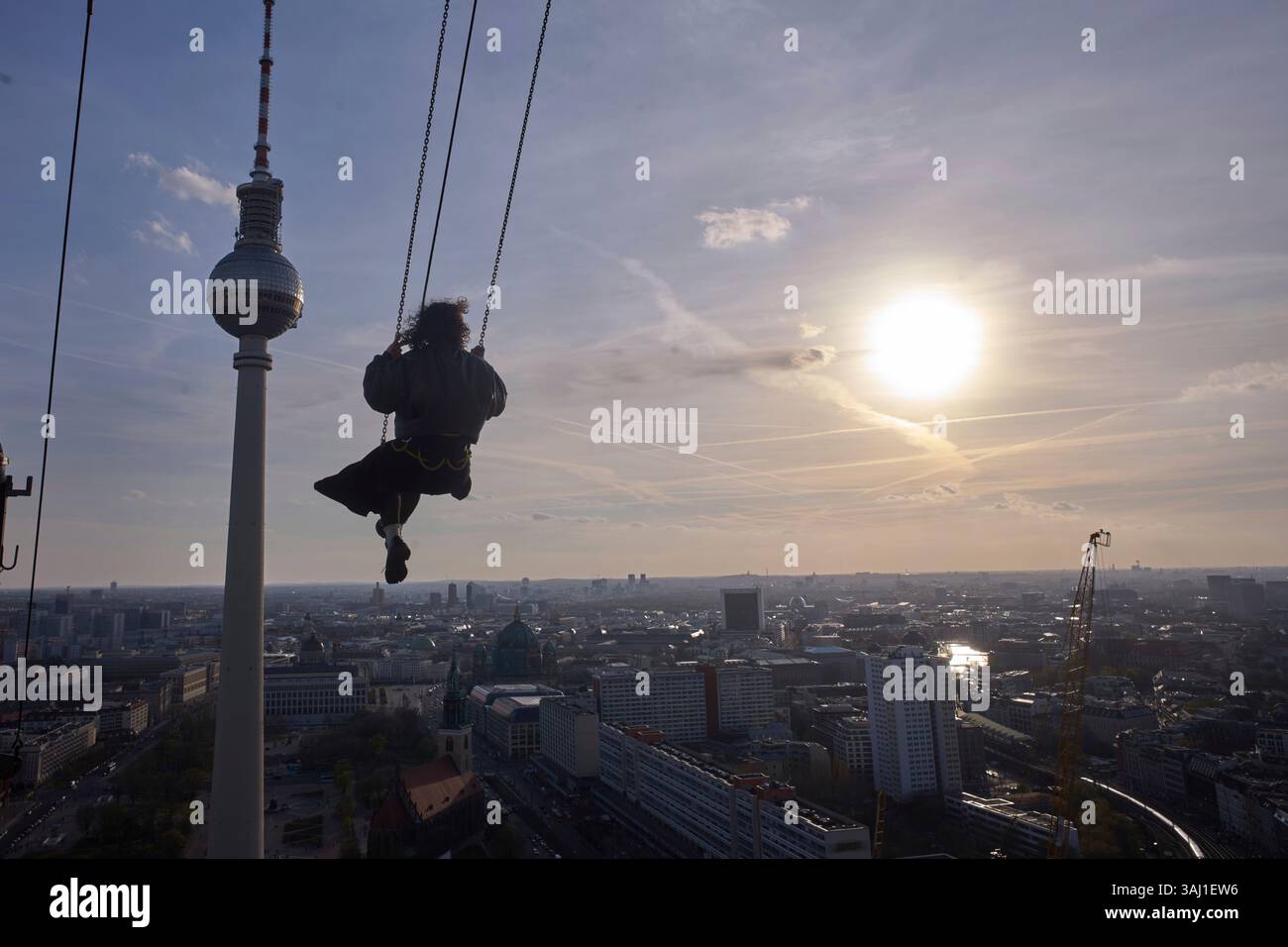 A woman swings on the High Swing Berlin at Alexanderplatz on a sunny ...
