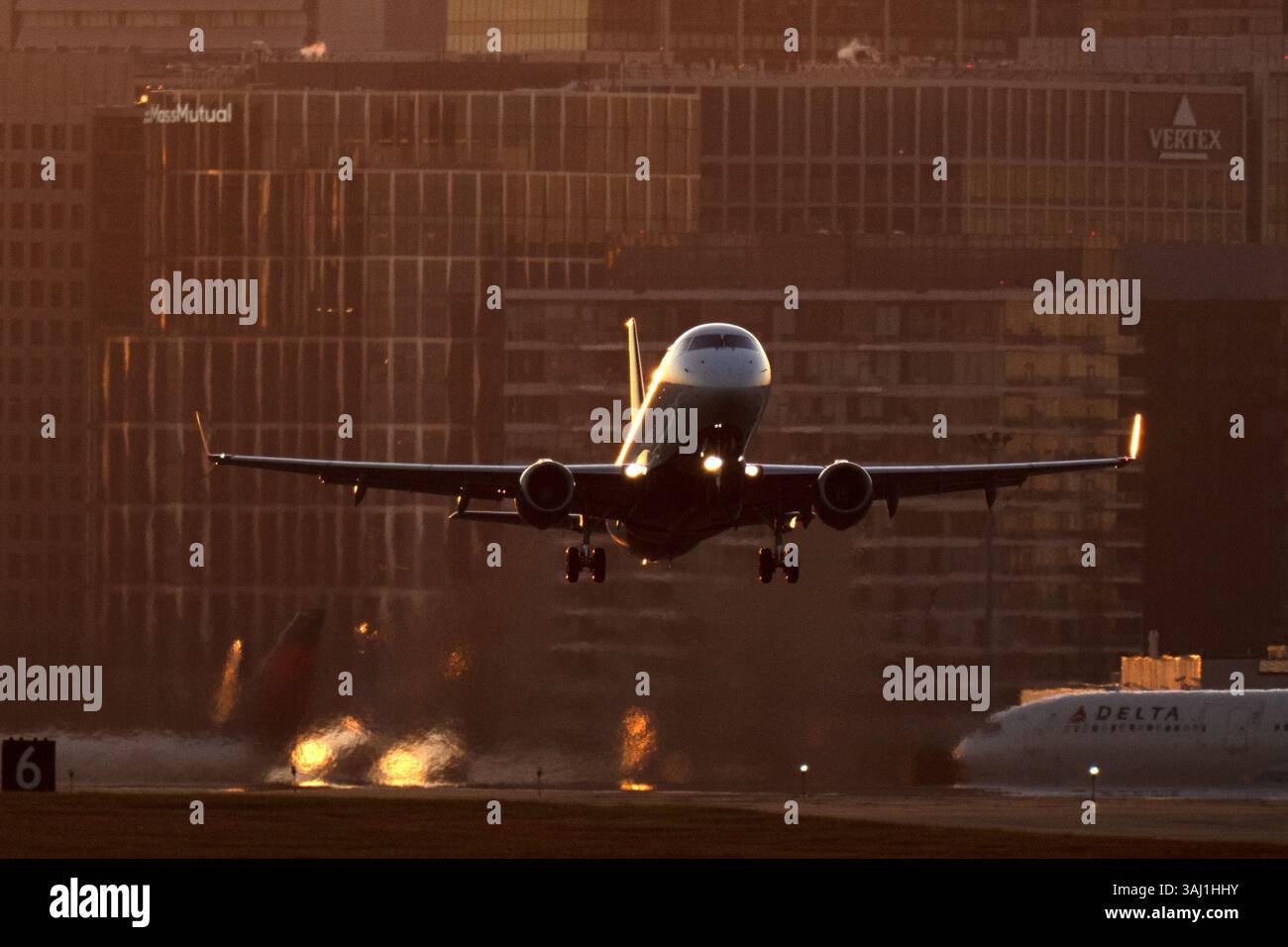 jet plane taking off from Logan International Airport city skyline ...