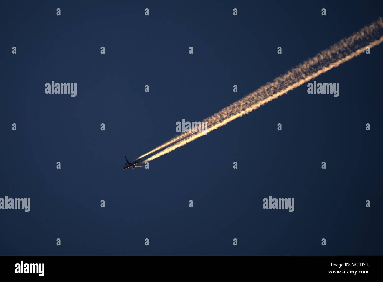 high jet and contrail deep blue sky Stock Photo - Alamy