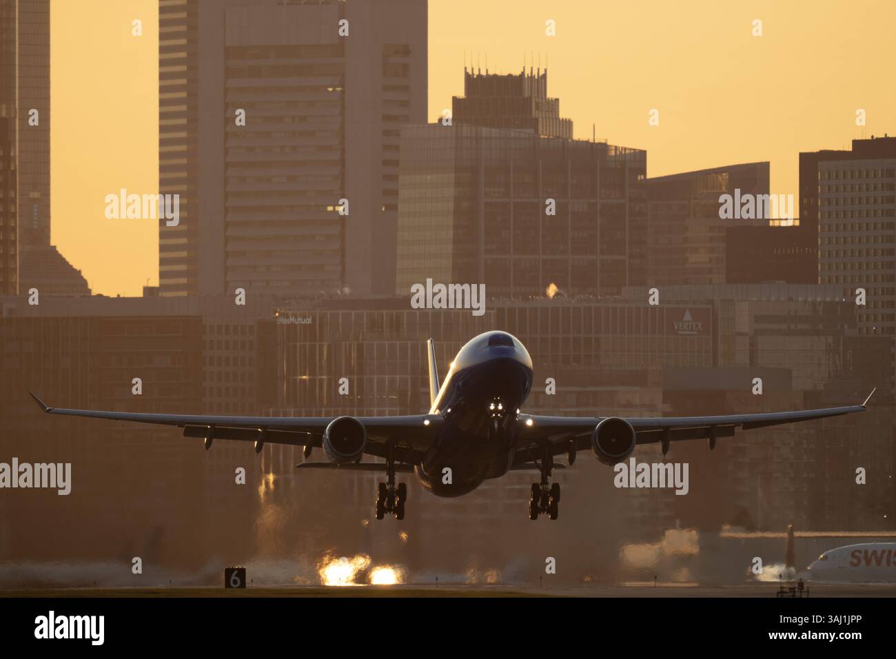 jet plane taking off from Logan International Airport city skyline ...