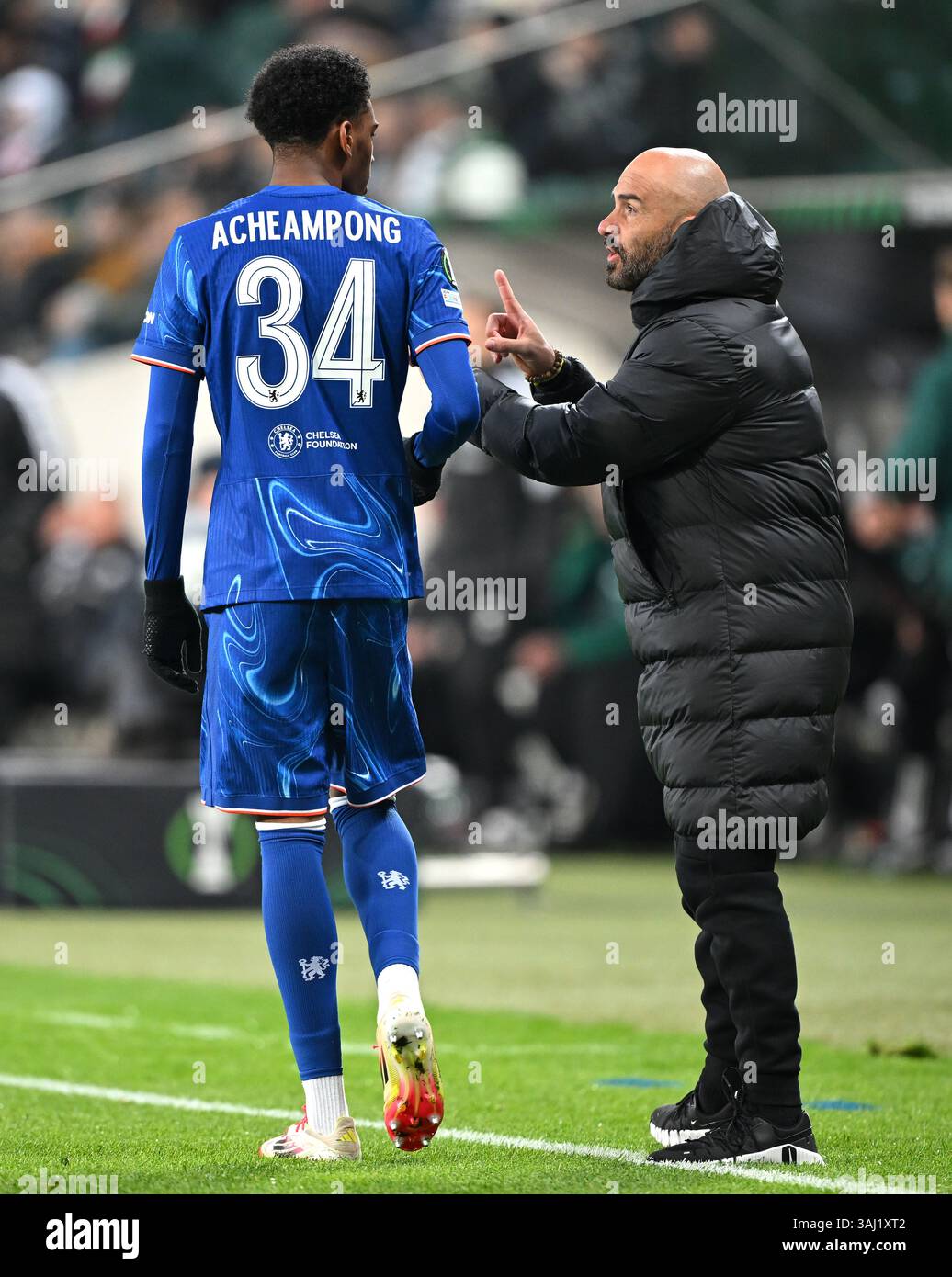 Chelsea manager Enzo Maresca addresses Josh Acheampong during the UEFA ...