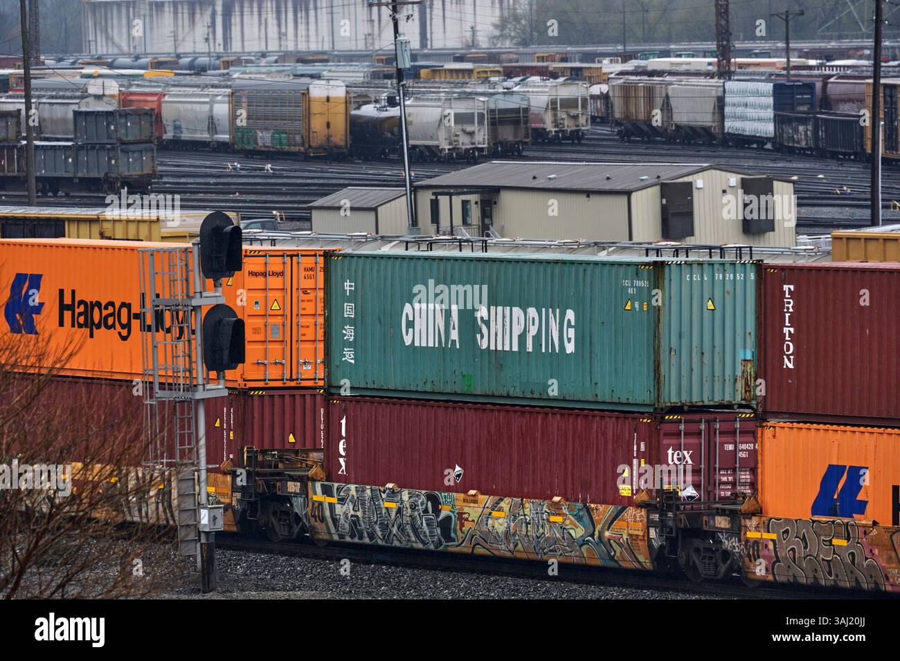 A Norfolk Southern freight pulling shipping containers enters the ...