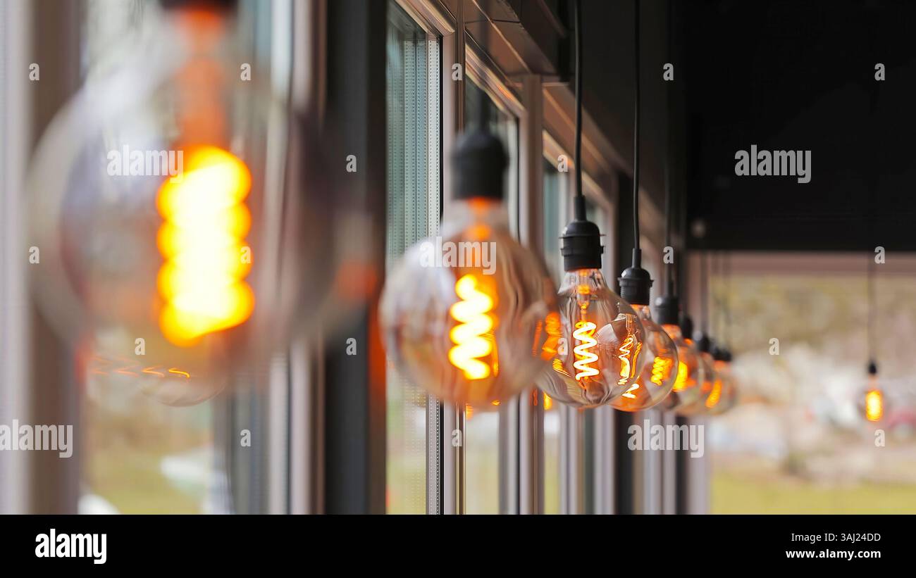 Row of Vintage Edison Bulbs in Window. Close-up of glowing vintage ...