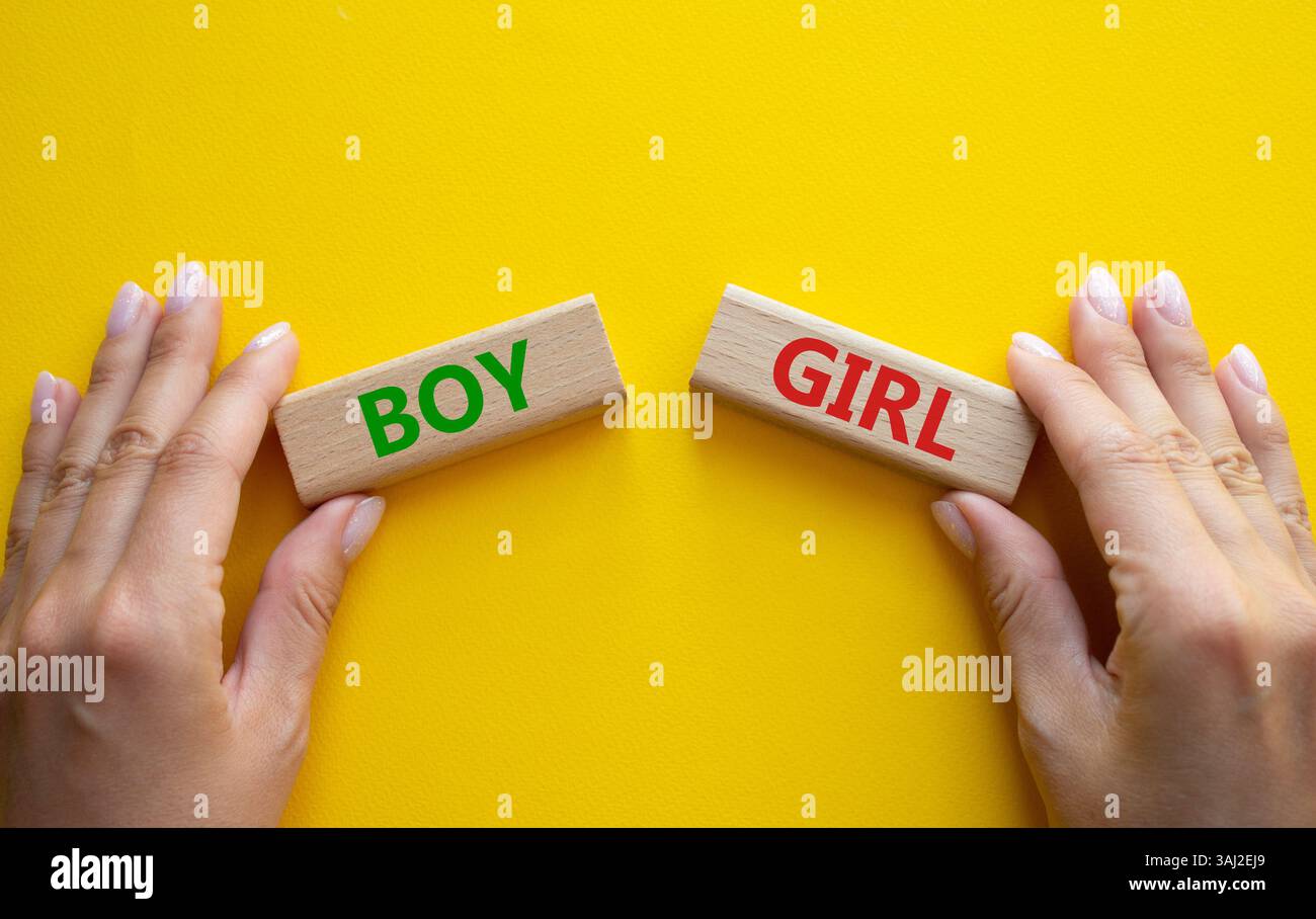 Boy or Girl symbol. Concept word Boy or Girl on wooden blocks. Man hand ...