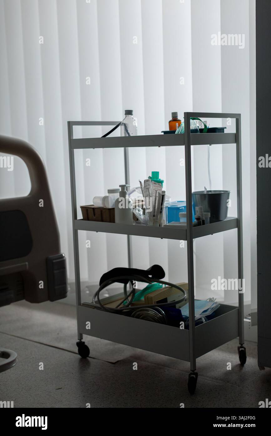 A Medical Utility Cart Equipped with Various Items Illuminated in Dim ...