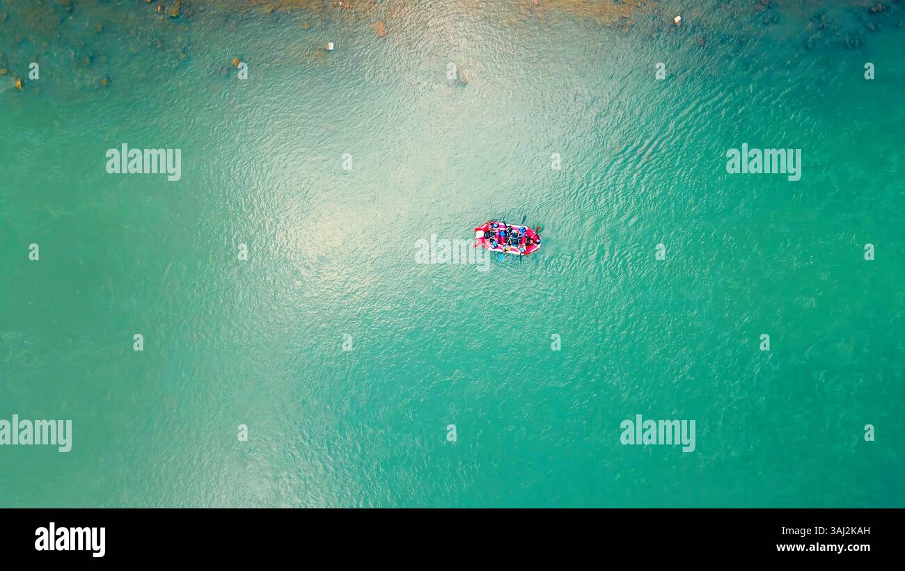 Aerial view of a group rafting on a calm river. A peaceful aerial shot ...