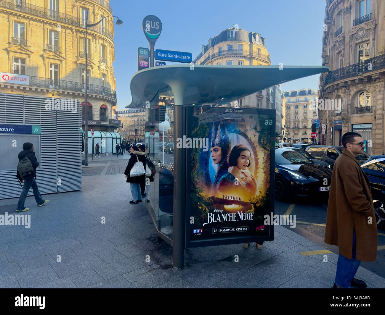 Urban bus stop in Paris features a vibrant poster for a new movie ...