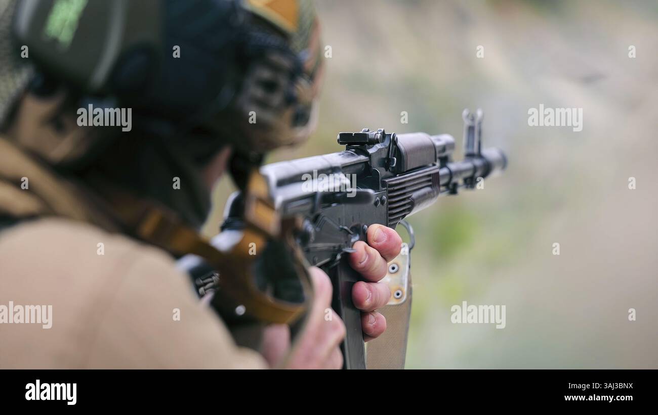 Soldier aiming rifle during a training exercise. A close-up view of a ...