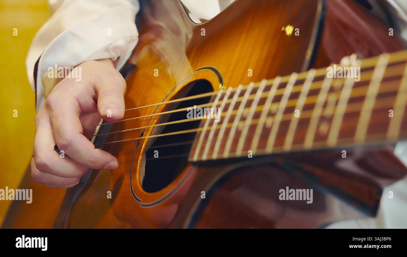 Close-Up of Acoustic Guitar Being Played. A detailed close-up view of a ...