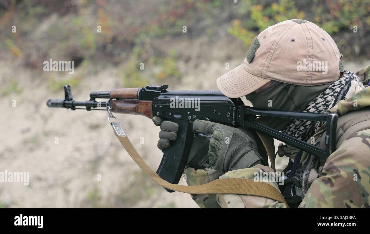 Soldier Aiming Rifle During Training. A soldier in camouflage gear and ...