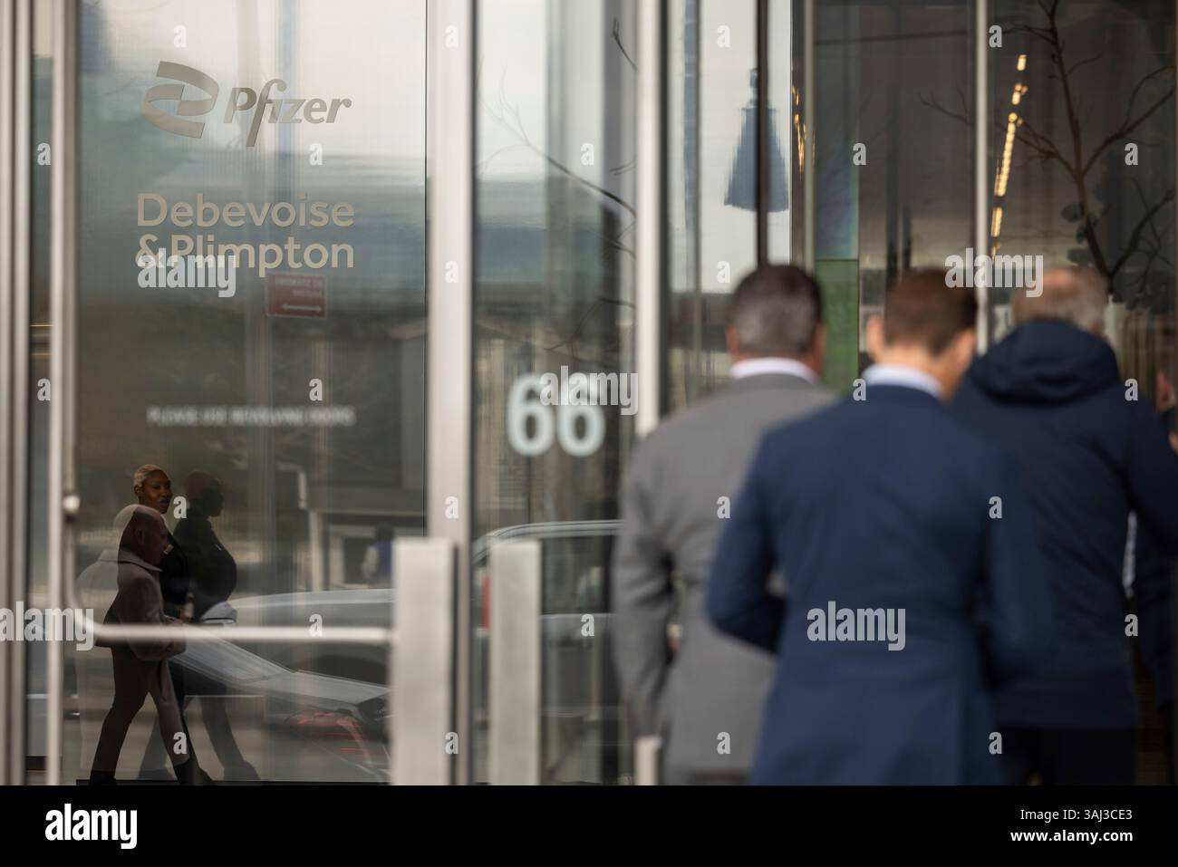 People enter the Pfizer NYC Headquarters, Thursday, April 10, 2025, in ...