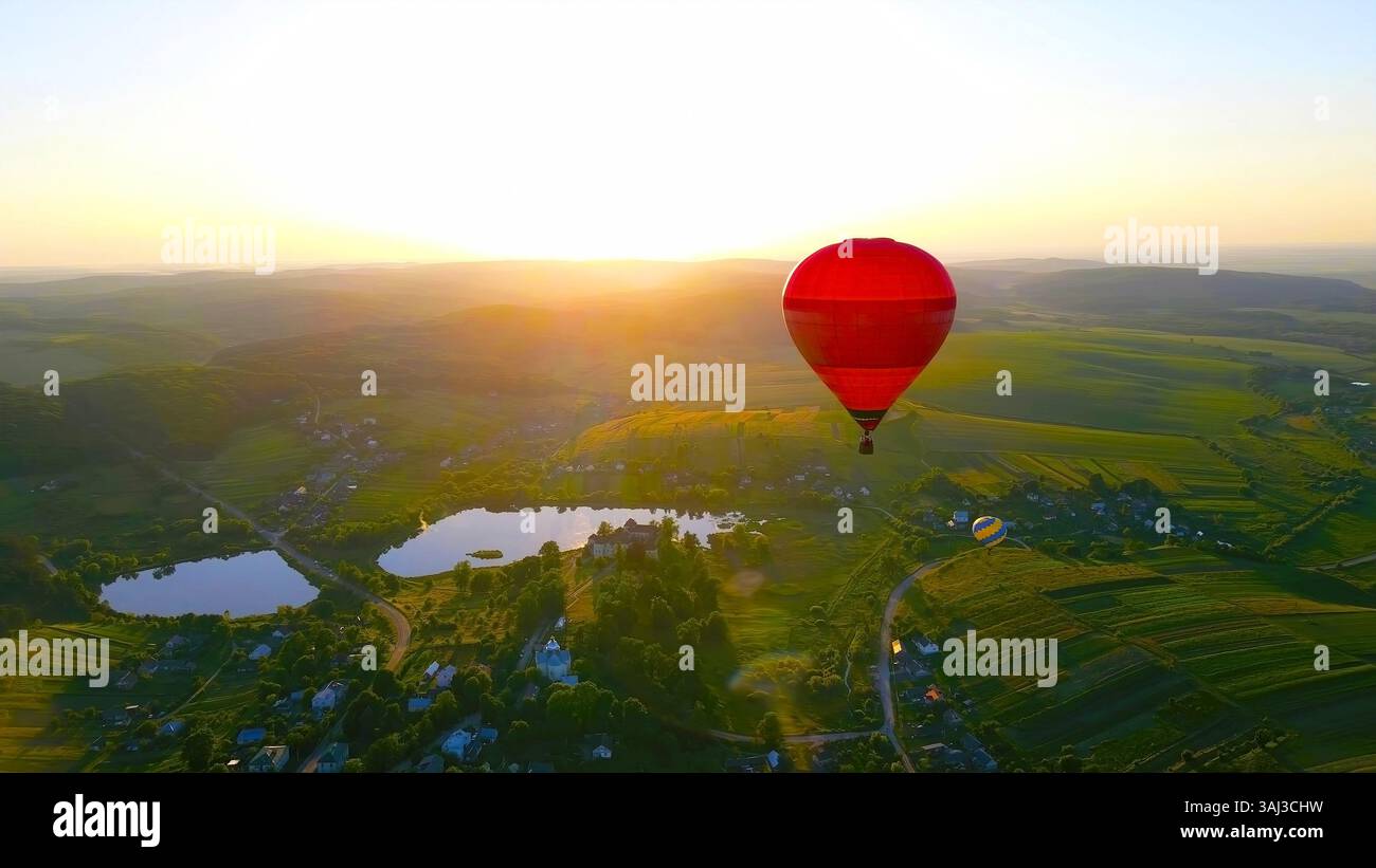 Hot Air Balloon Over Countryside at Sunset. A breathtaking aerial view ...