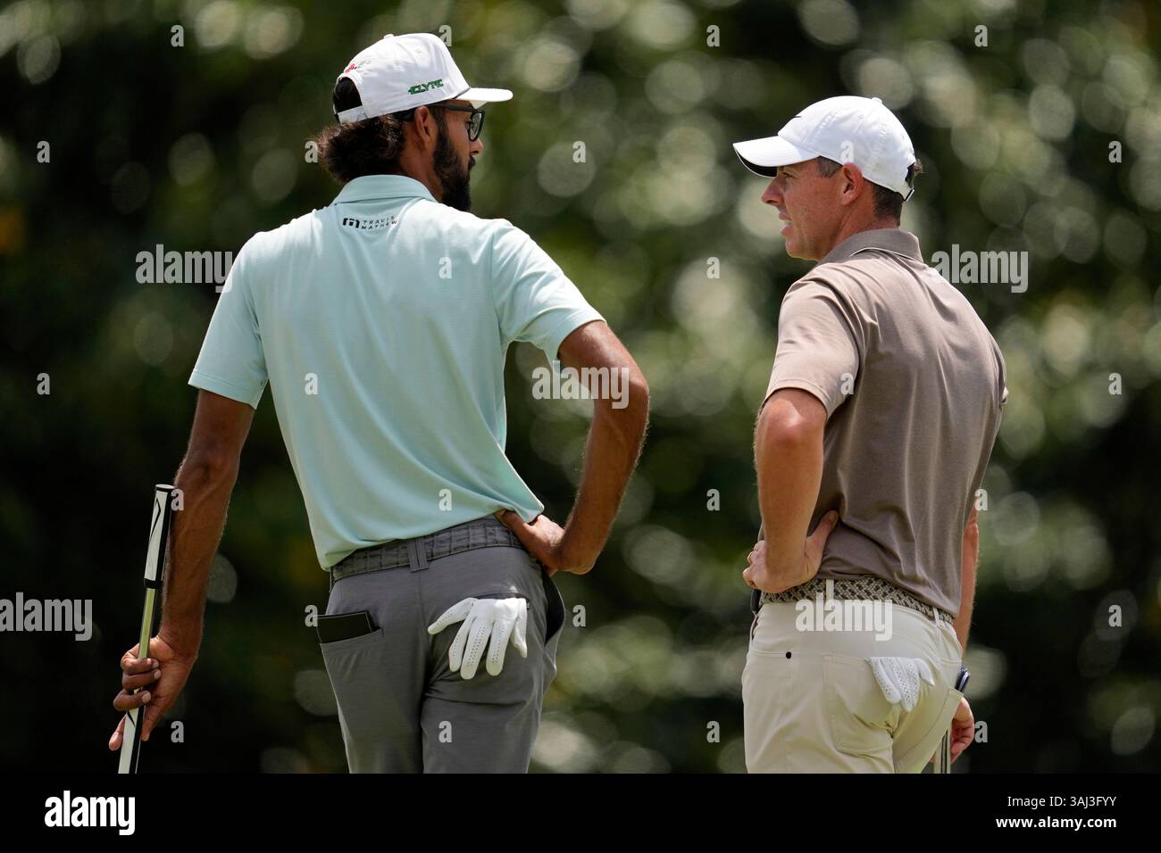 Rory McIlroy, of Northern Ireland, and Akshay Bhatia talk on the first ...
