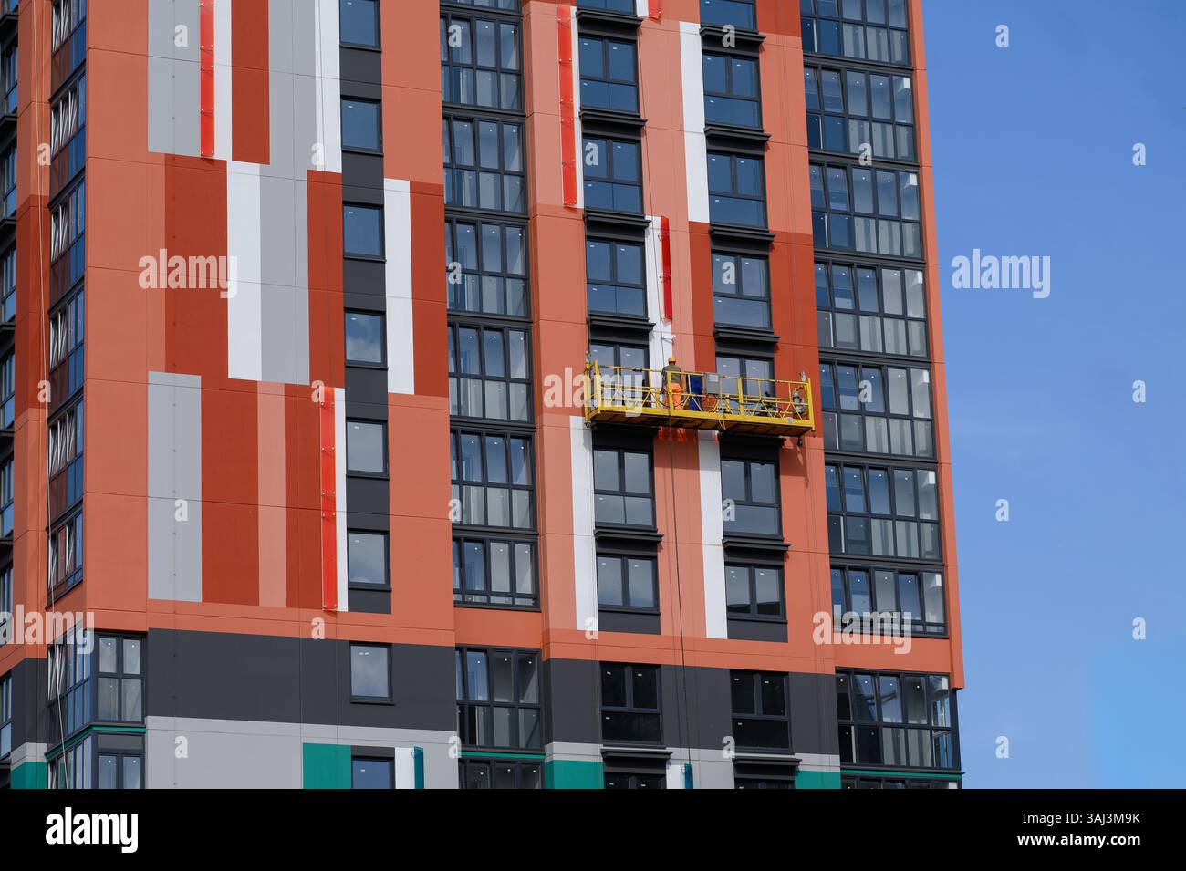 Worker is engaged in external works, insulation of house, renovation ...