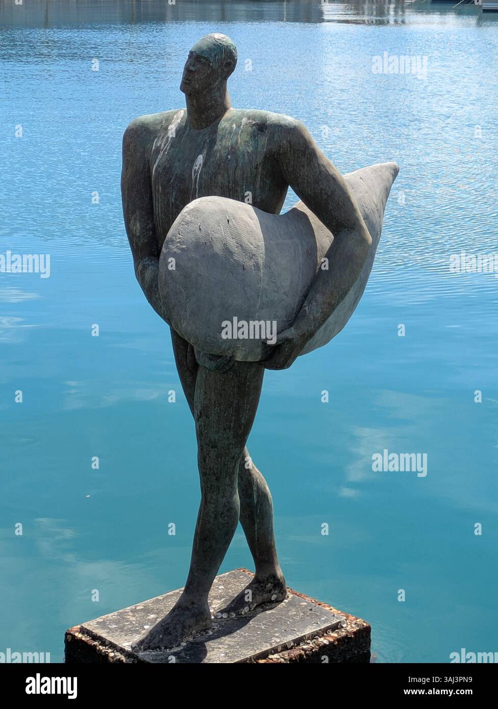 stone sculpture of Icarus carrying wing surfboard at Alicante harbour ...