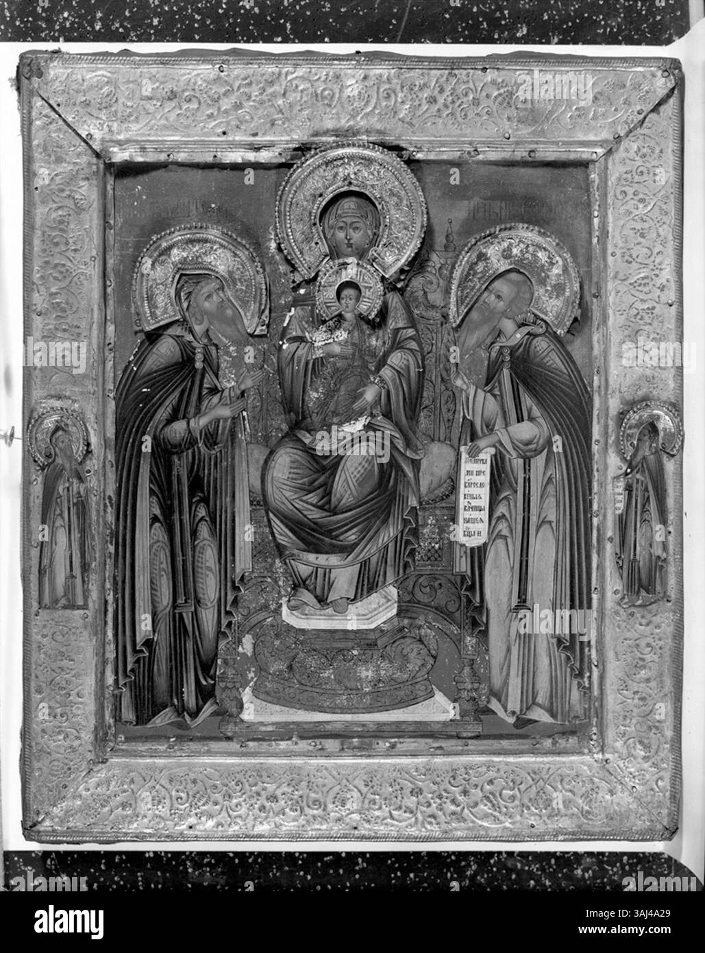 This 18th-century painting depicts the Madonna and Child seated on a throne, flanked by two ...