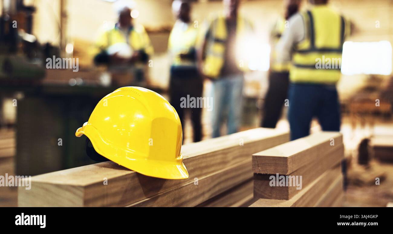 Wood, carpentry and helmet for safety at warehouse with engineer group ...