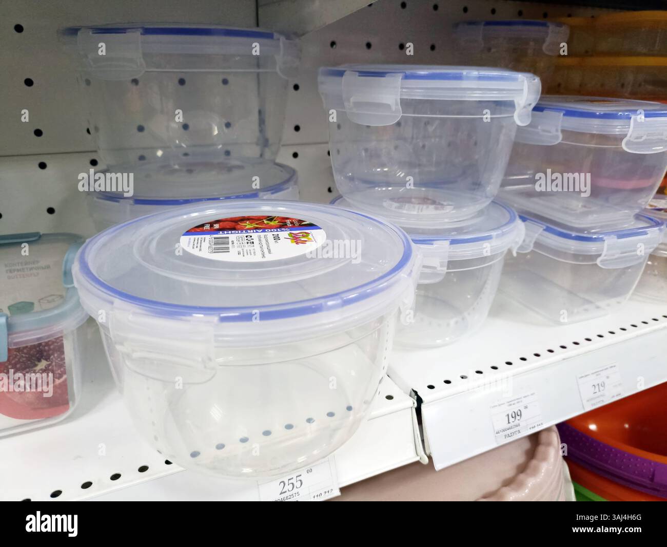 Plastic food storage containers on retail display shelf with pricing ...