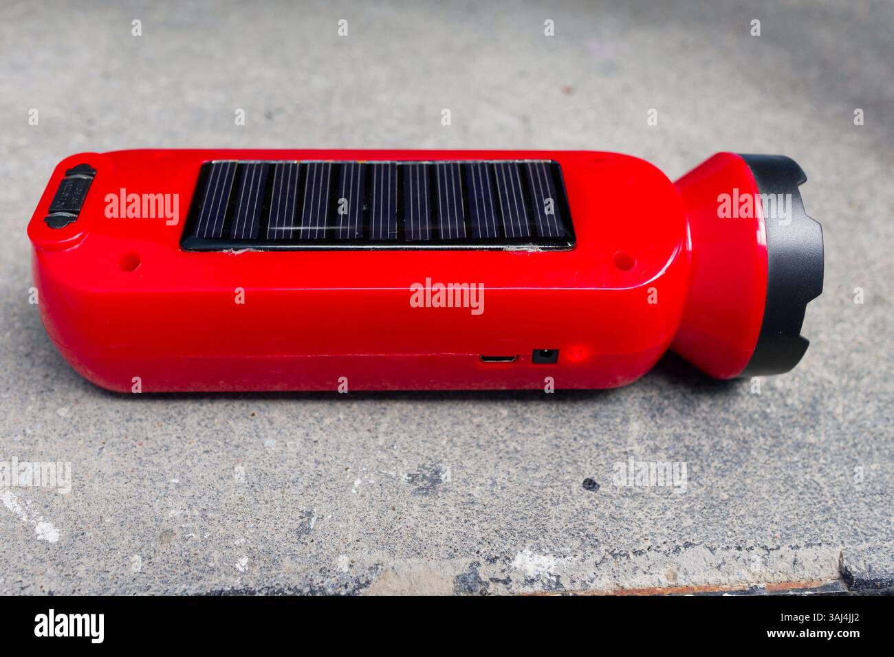 Dual charging red flashlight with small solar panel on the topside ...