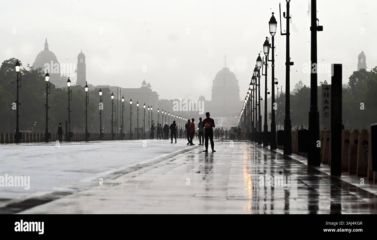 NEW DELHI, INDIA - APRIL 10: Visitors during sudden rain at Kartavya Path, India Gate on April ...