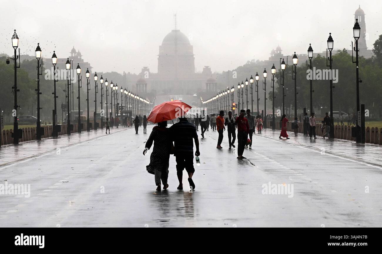 NEW DELHI, INDIA - APRIL 10: Visitors during sudden rain at Kartavya Path, India Gate on April ...
