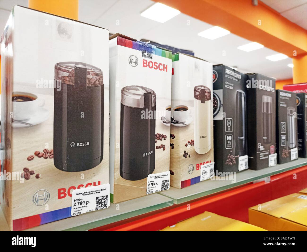 Variety of coffee grinders displayed on store shelf with packaging ...