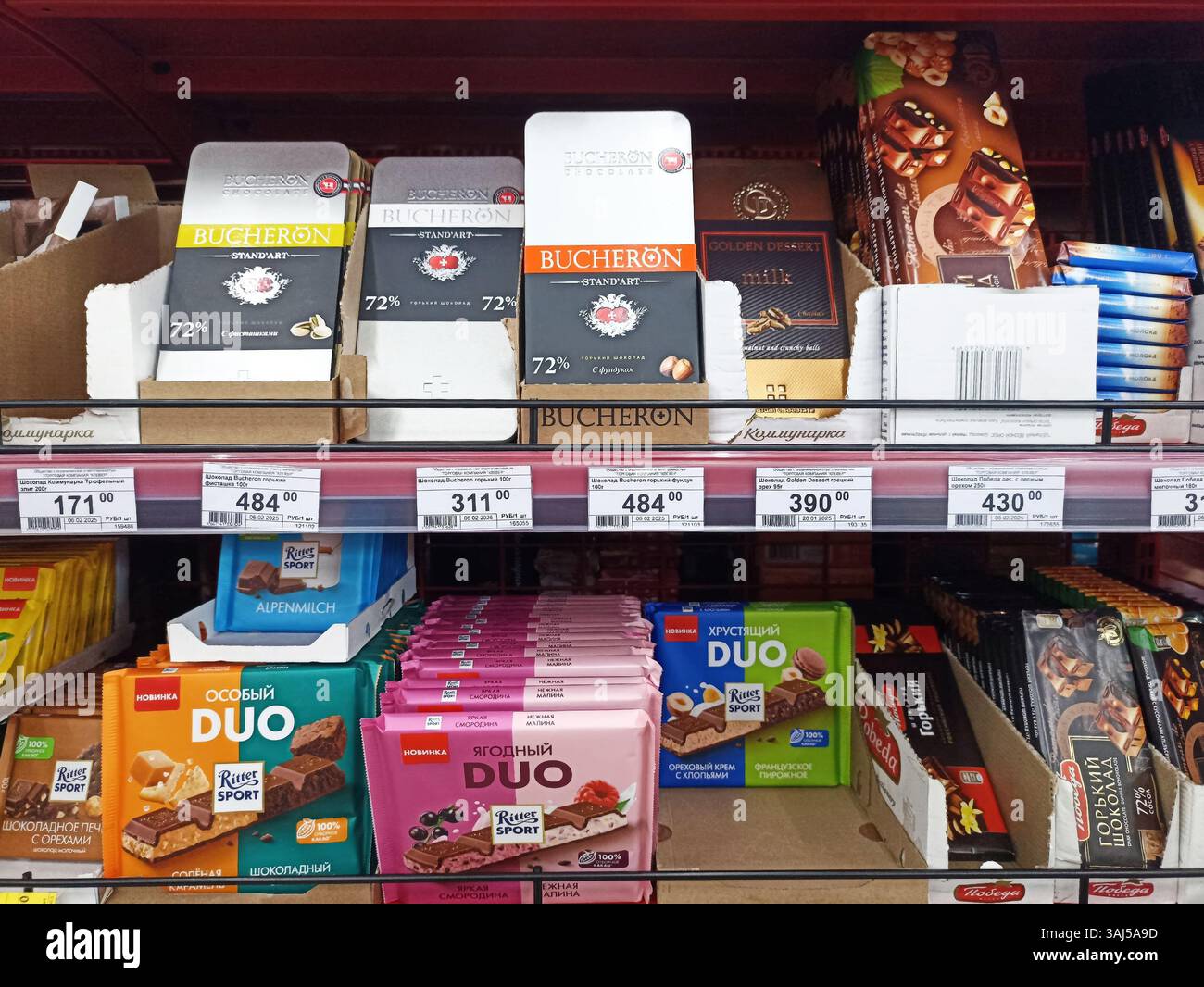 Assorted chocolate bars on store shelves with various brands and ...