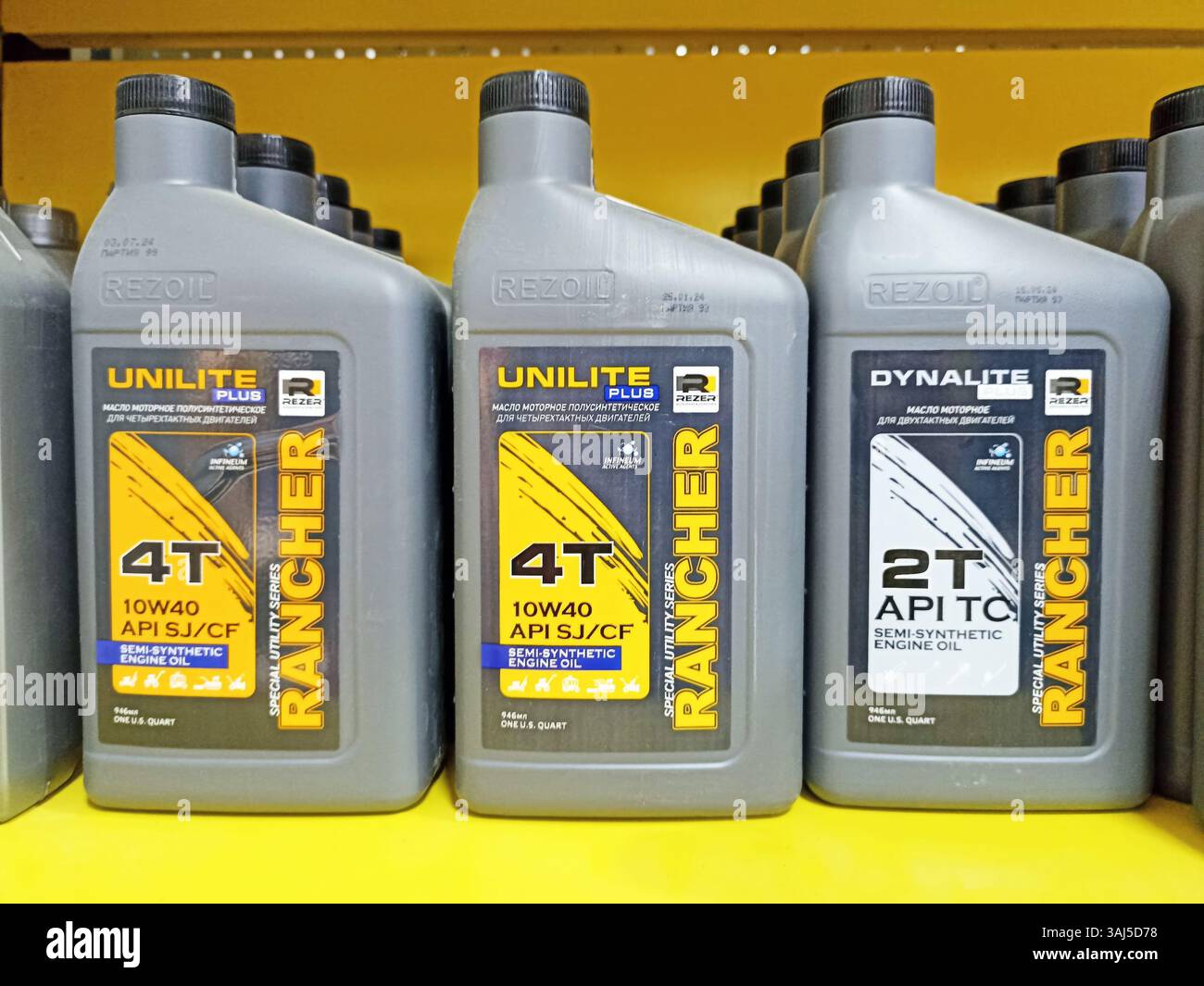 Motor oil bottles display on shelf with unilite and dynalite labels ...