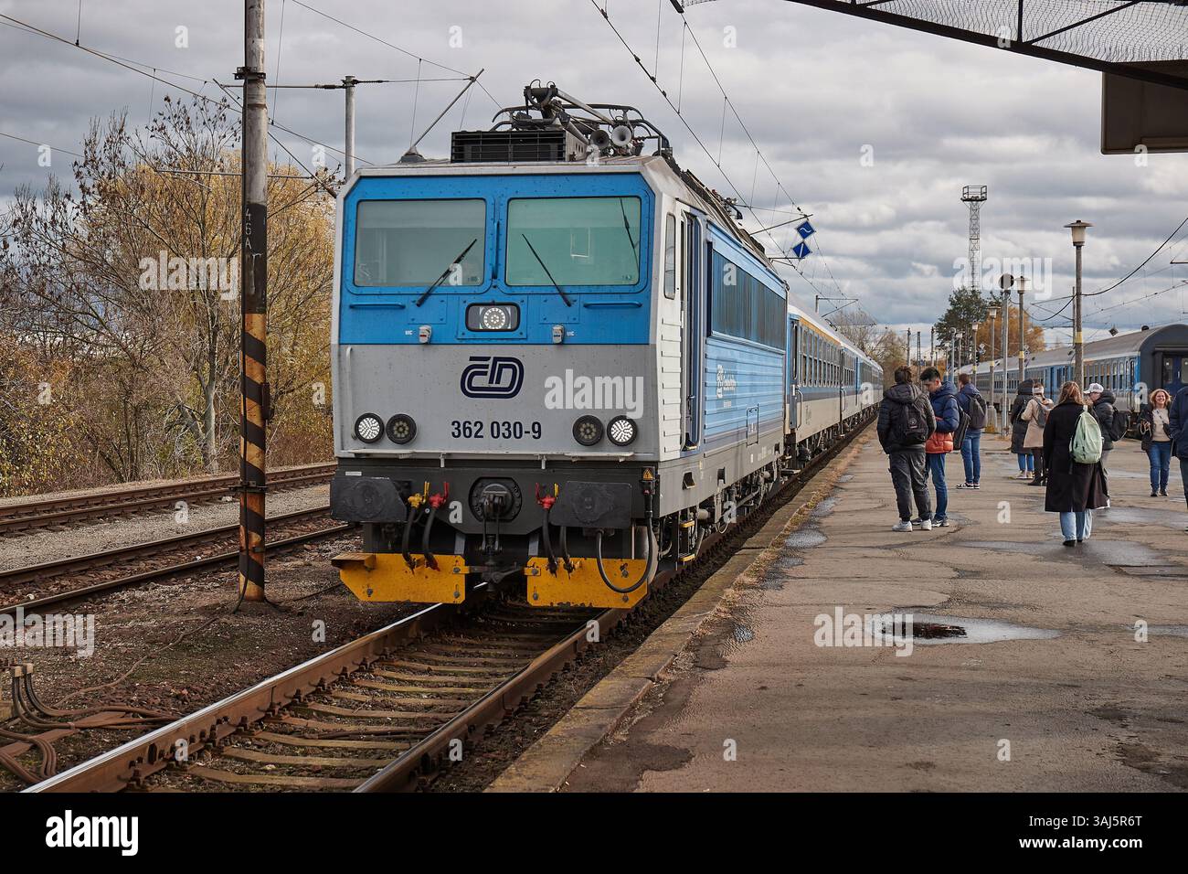 Passenger train arriving at railway station Stock Photo - Alamy