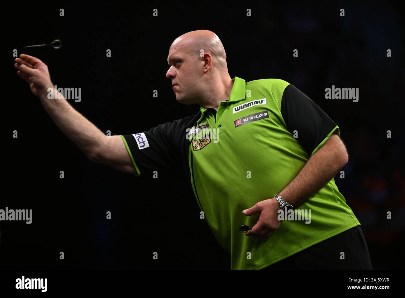 Michael van Gerwen throws a dart during his match against Chris Dobey ...