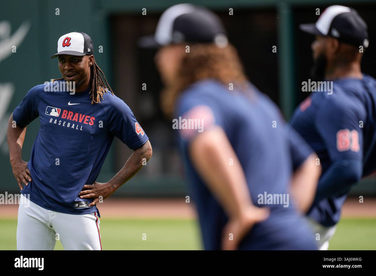 Atlanta Braves pitcher Rafael Montero, left, warms up with the team ...