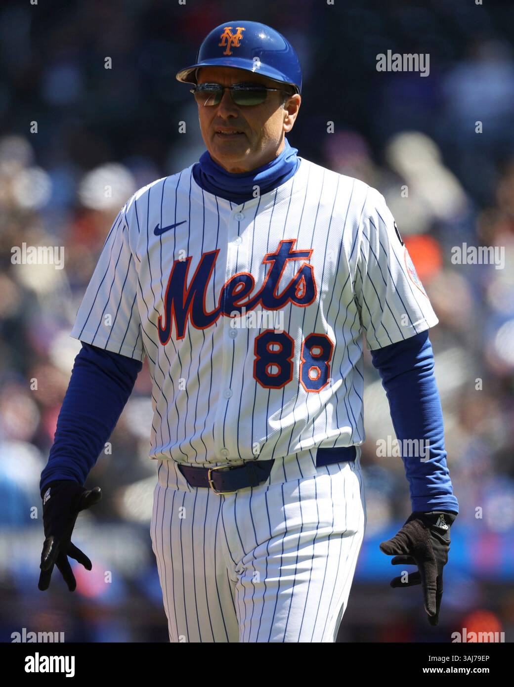 New York Mets third base coach Mike Sarbaugh stands on the field during ...