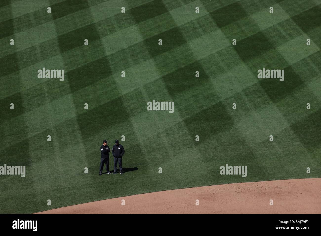 MLB umpires stand on the field during the sixth inning of a baseball ...