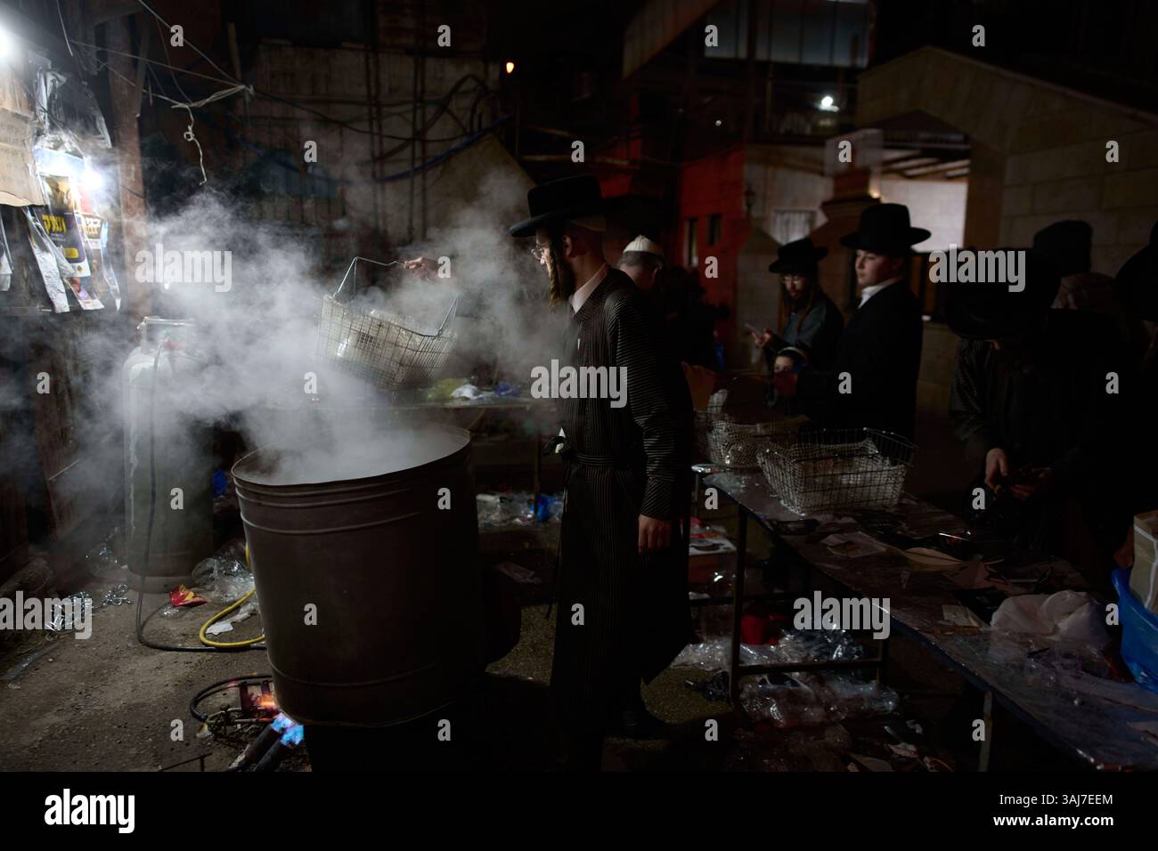 Ultra-Orthodox Jewish men clean their new cooking utensils in a water ...