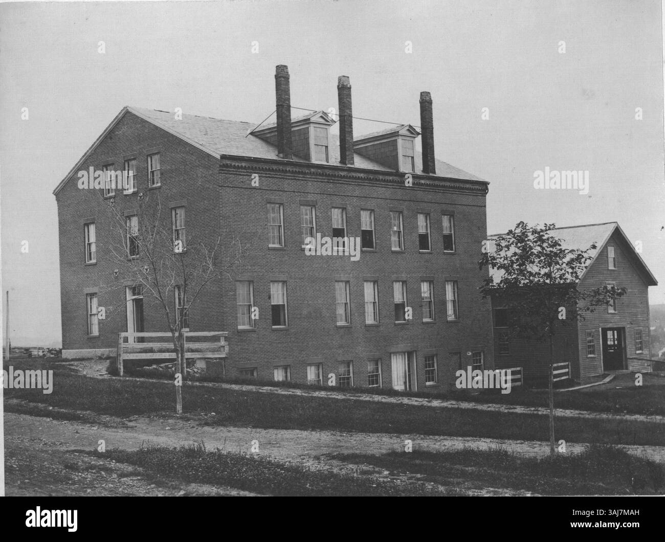 Packard Hall and the barn, photographed around 1860, represent ...
