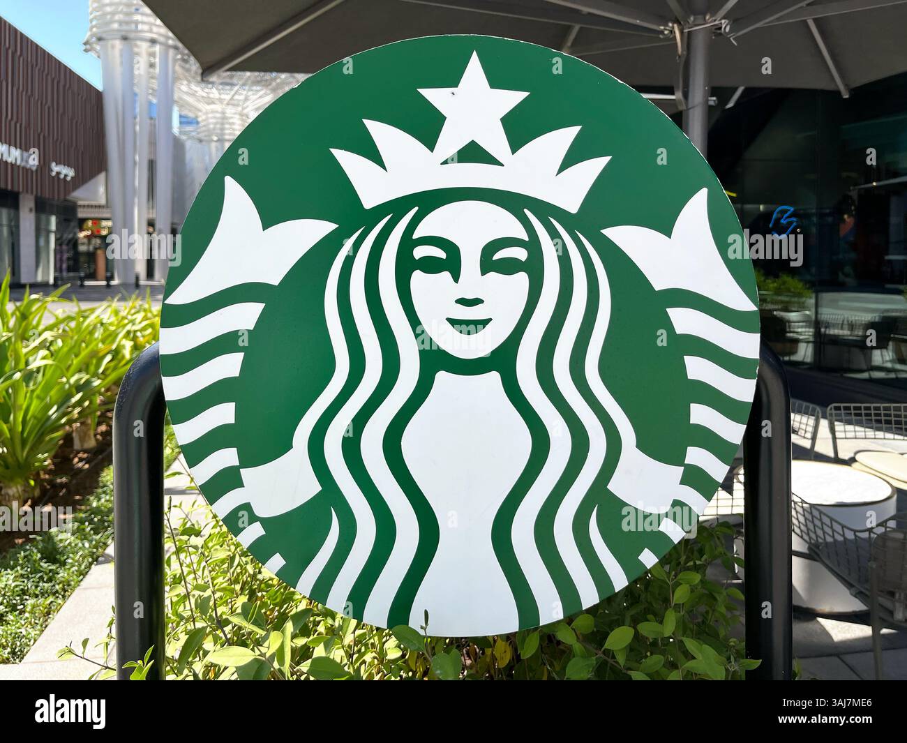 Starbucks logo placed on a round green and white sign in a cafe ...