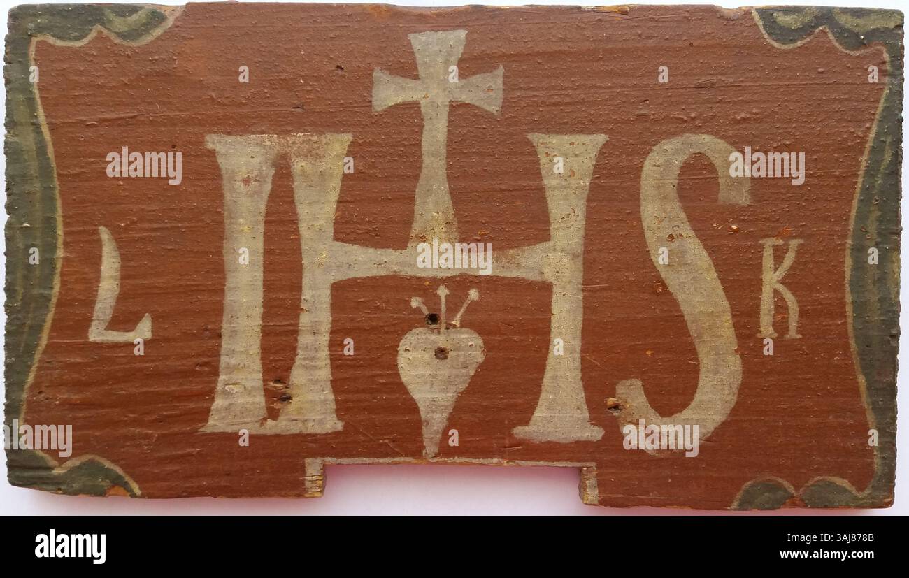 This 19th-century oil on panel painting, titled 'IHS,' features the ...