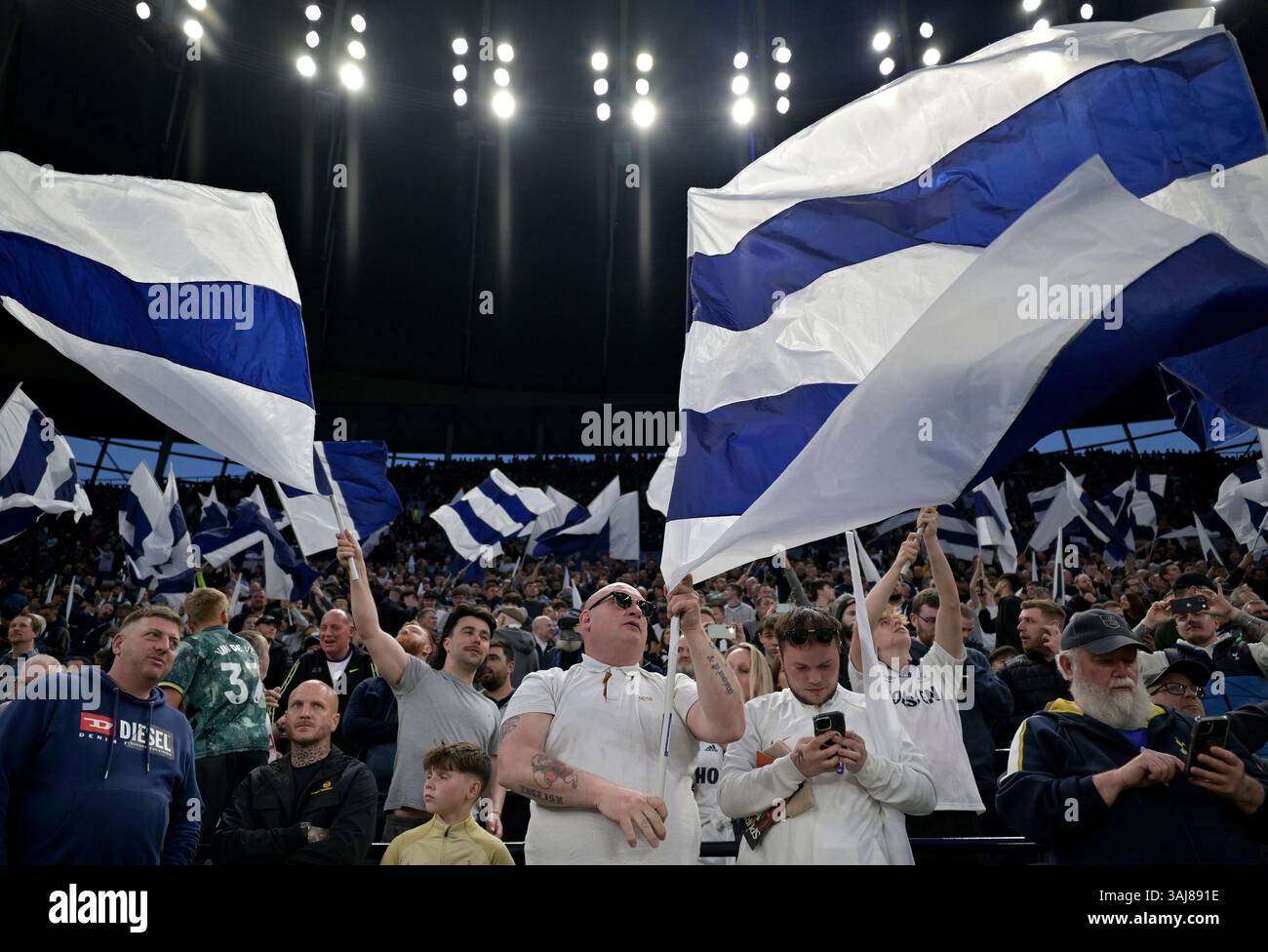 London, UK. 10th Apr, 2025. Spurs fans wave flags during the Tottenham ...