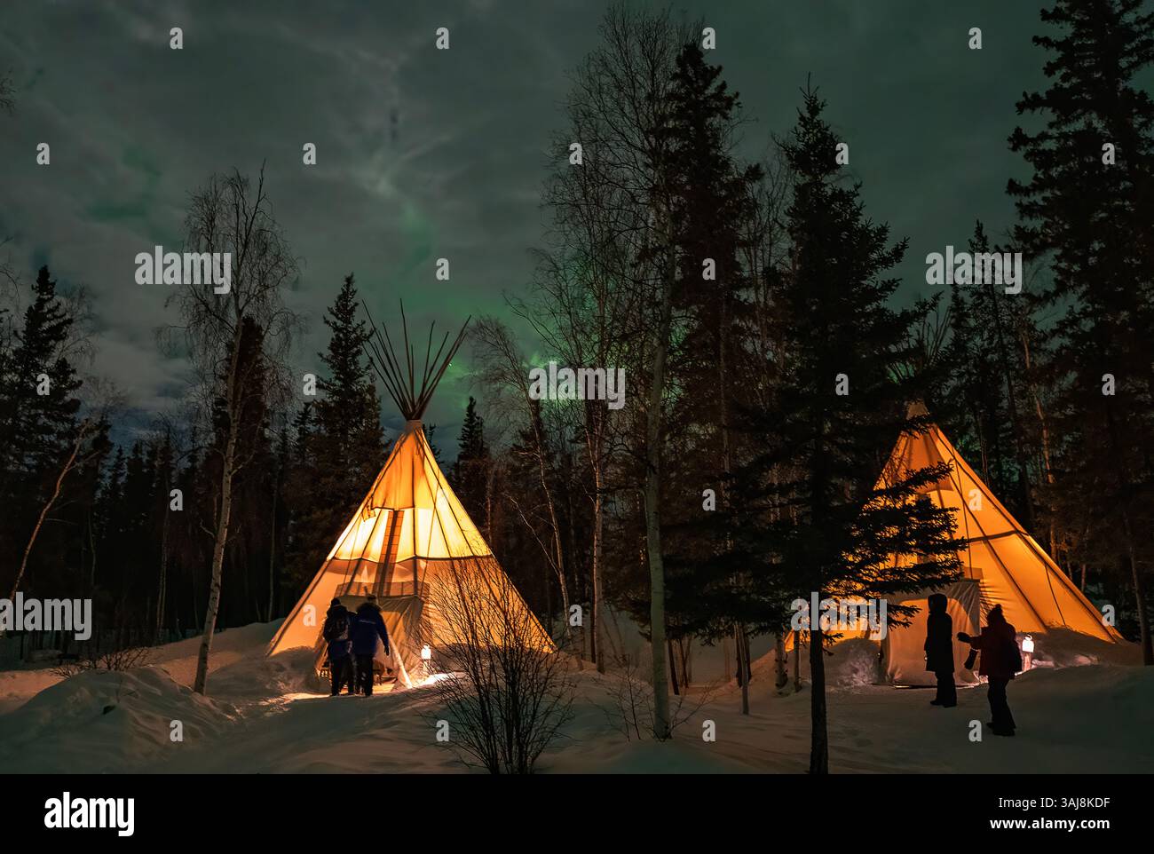 The Northern Lights (Aurora Borealis) above illuminated teepees in the ...