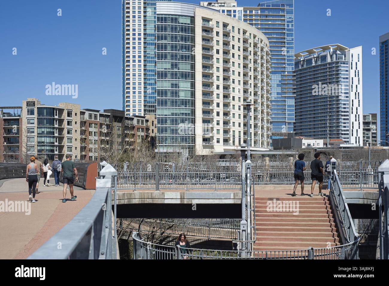 People walking on the approach to the Pfluger Pedestrian Bridge in ...