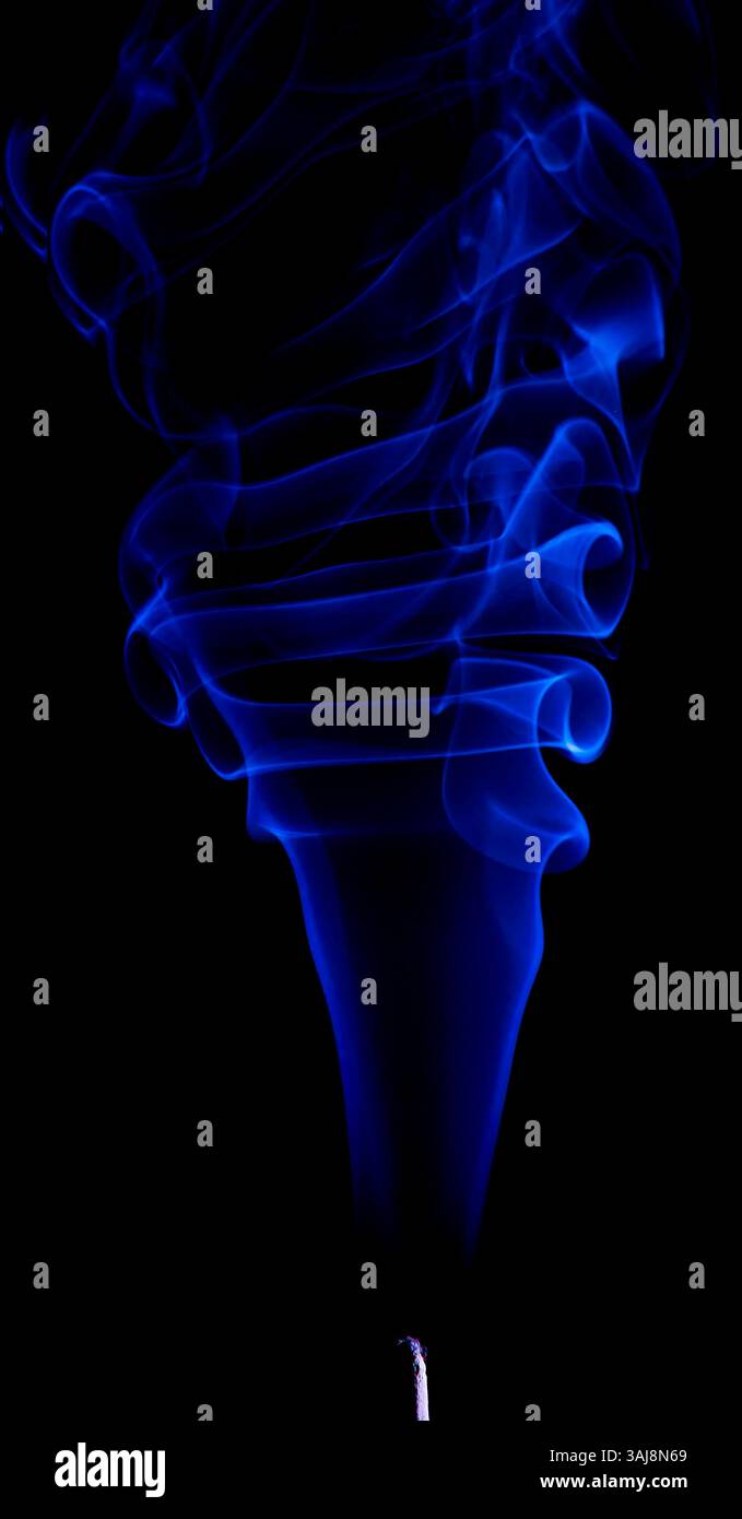 Rolling Blue smoke on a black background from incense stick Stock Photo ...