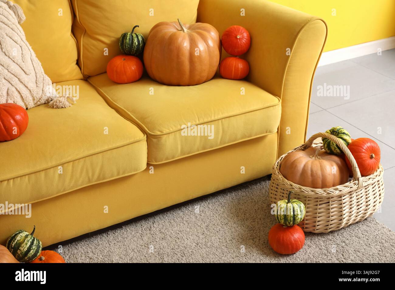 Living room interior with yellow sofa and wicker basket of different ...