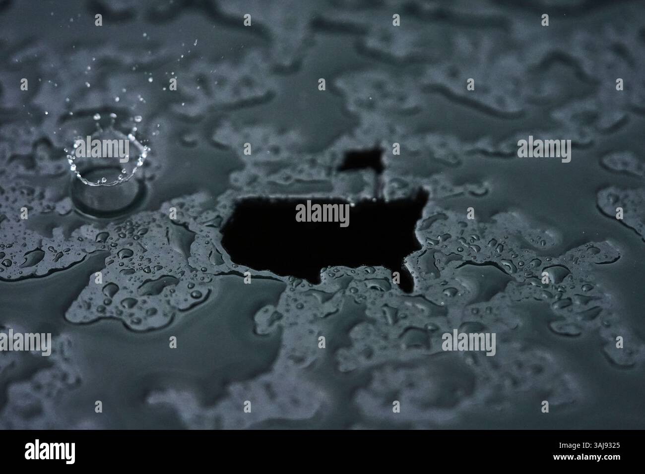 A raindrop splashes alongside a Masters Tournament logo at the Augusta ...