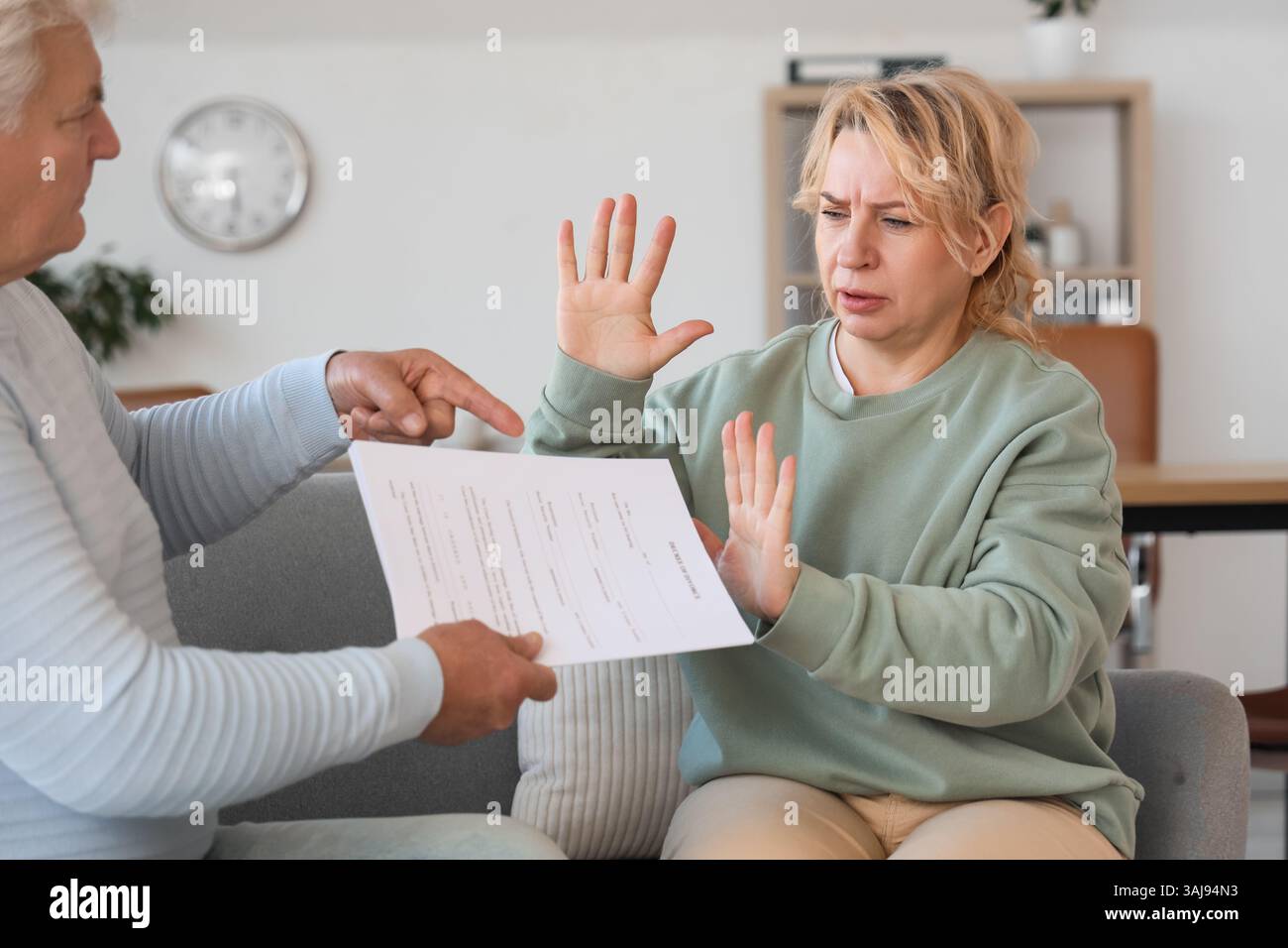 Mature woman refusing to sign divorce decree from her husband at lawyer ...