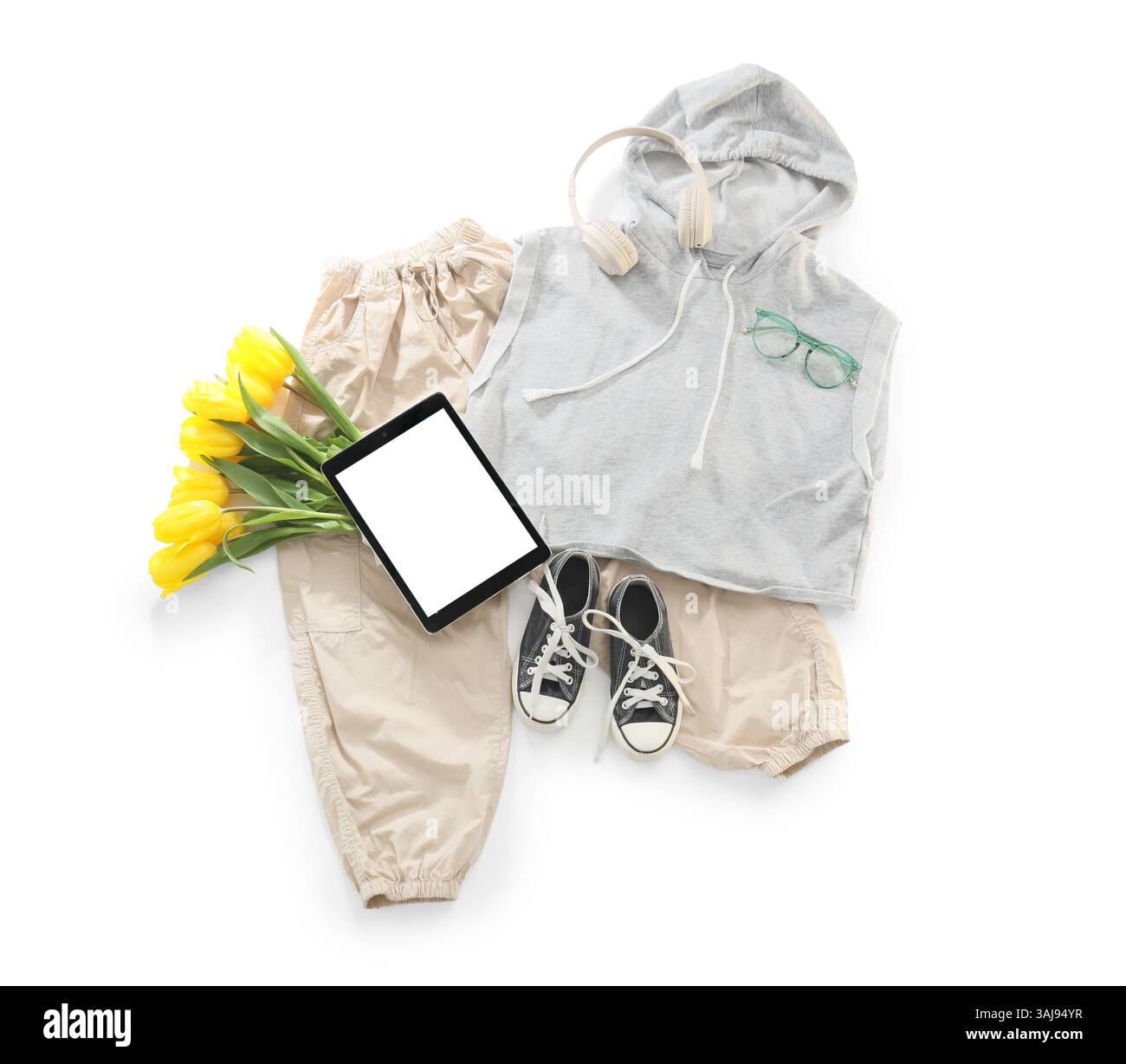 Stylish children's clothes, headphones, tablet computer and tulip ...