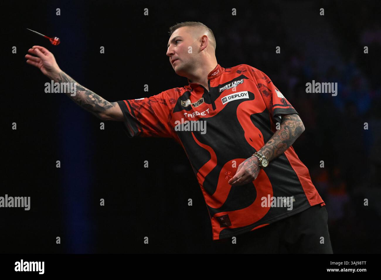 Nathan Aspinall throws a dart during his Rob Cross match against ...