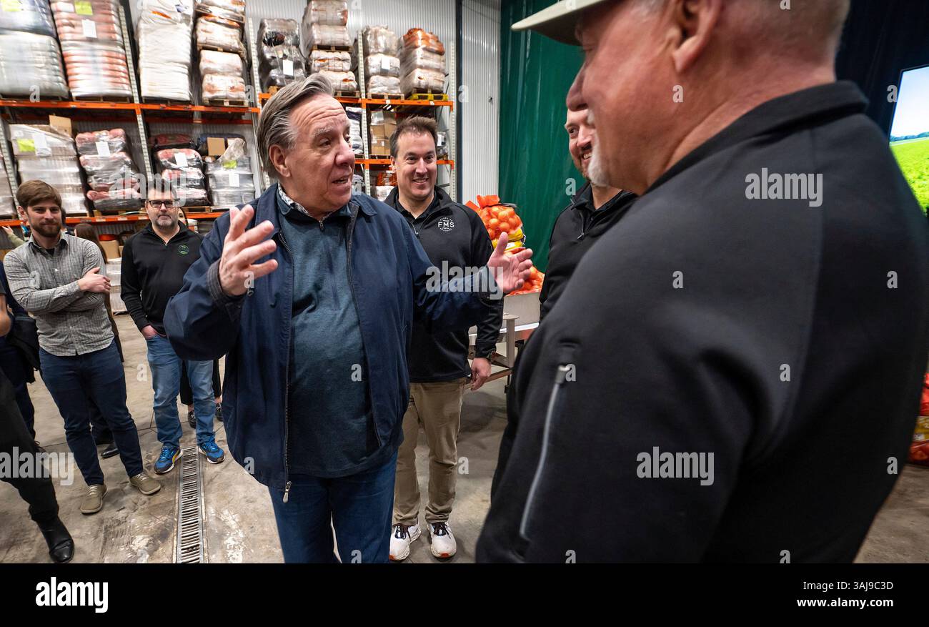 Quebec Premier Francois Legault talks with farmers/owners of FMS ...