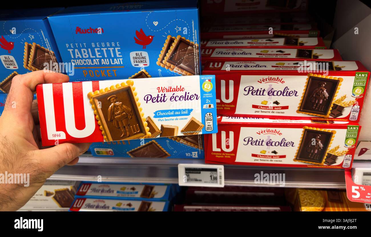 Paris, France - Feb 13, 2025: A hand holds a pack of LU Veritable Petit ...